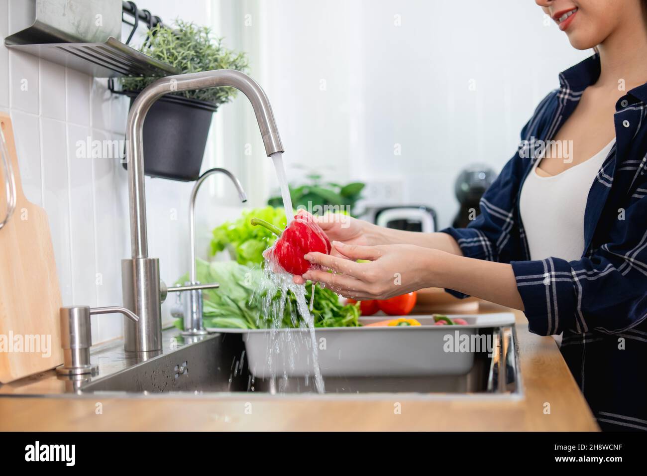 Close up Asian healthy woman washing vegetable above kitchen sink Stock ...