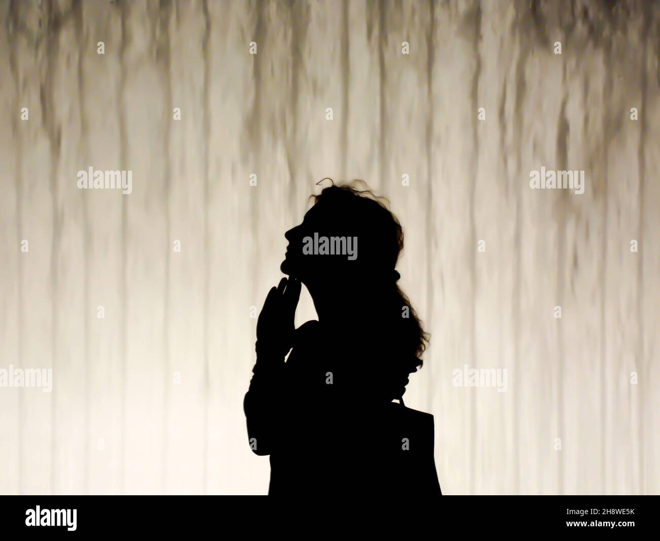 Female figure praying by the fountain Stock Photo - Alamy