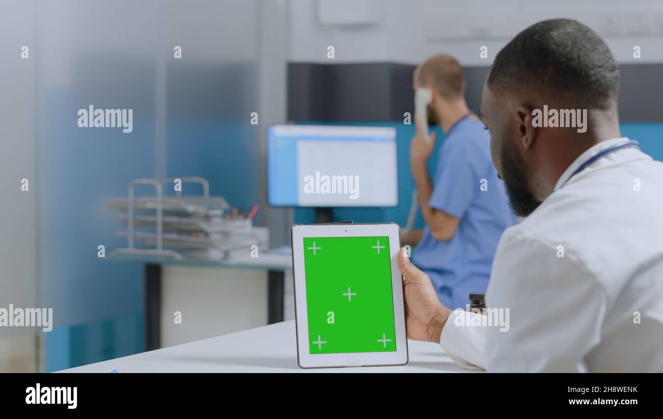 African american therapist doctor looking at mock up green screen ...