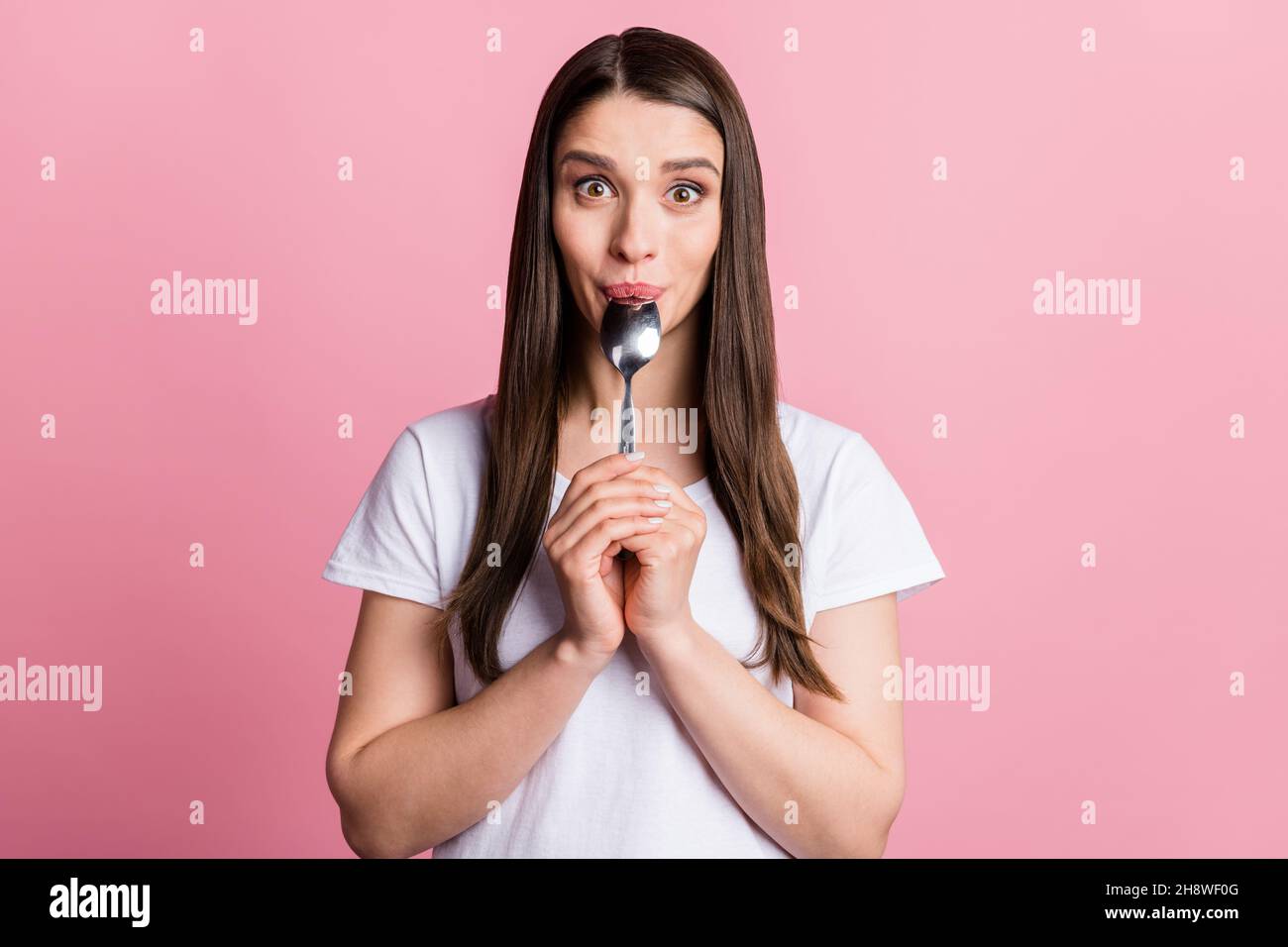 Photo portrait young woman licking spoon hungry isolated pastel pink ...