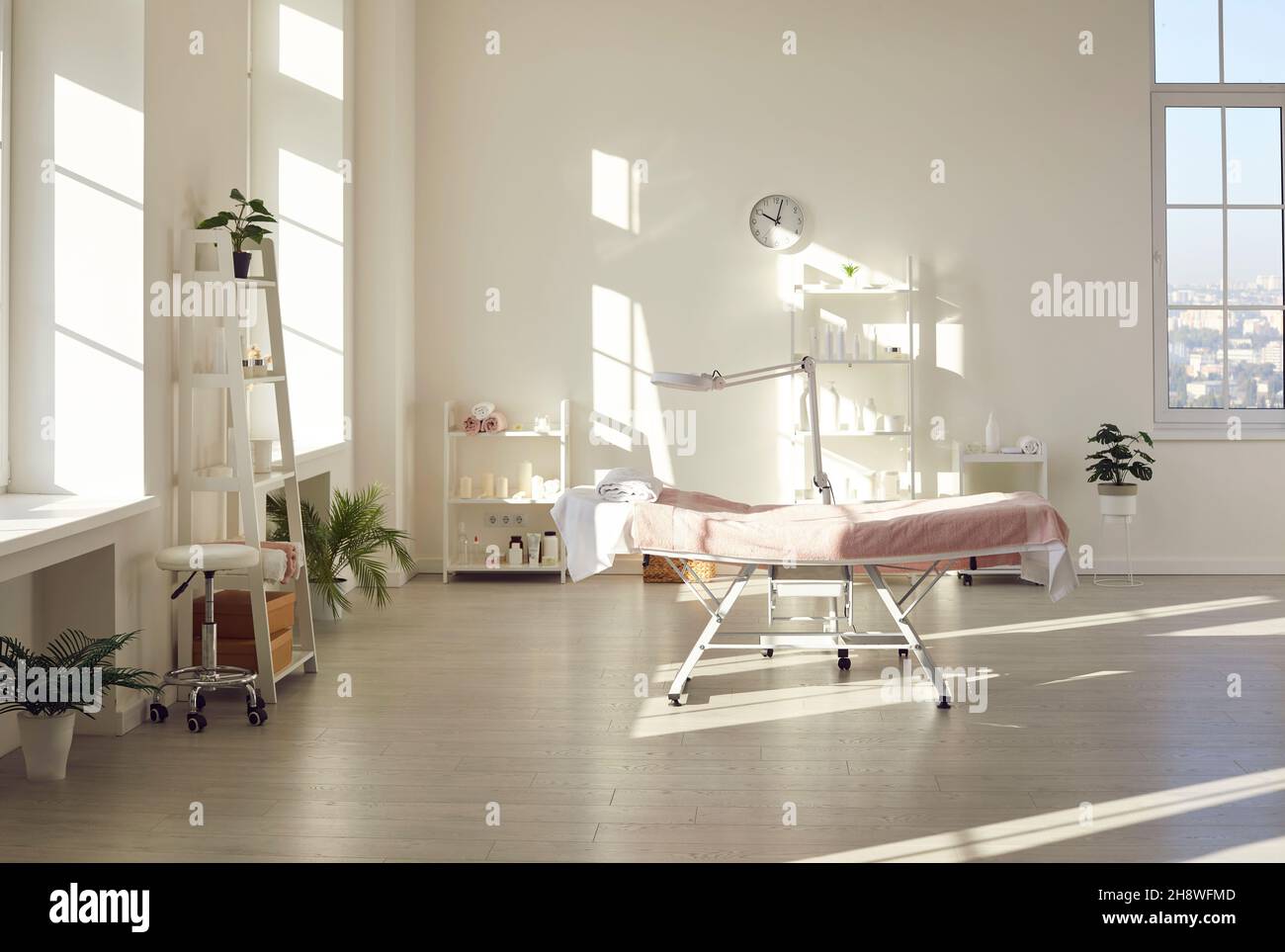 Empty massage room, spa center, or beauty salon with massage bed and ...