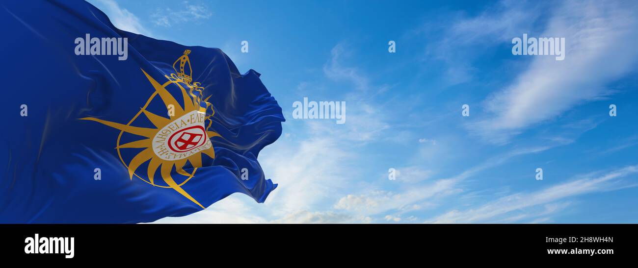 flag of Anglican rose at cloudy sky background on sunset. panoramic ...