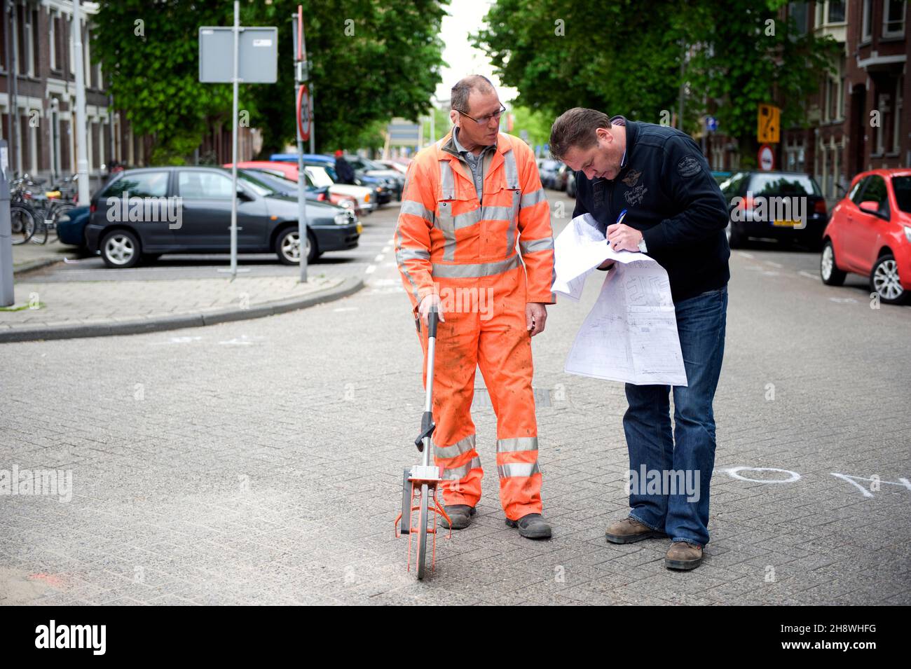 Two Professionals and Inspectors Inspecting the neighbourhood Sewer ...