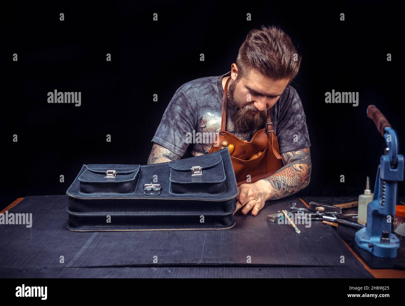 Leather Artist produce a leatherwork at his shop Stock Photo - Alamy