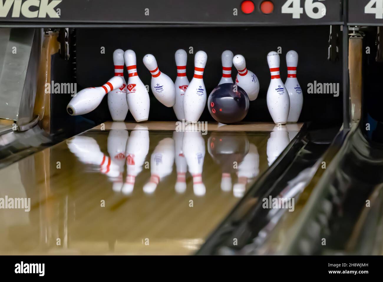 Bowling ball hitting pins at a bowling alley Stock Photo - Alamy