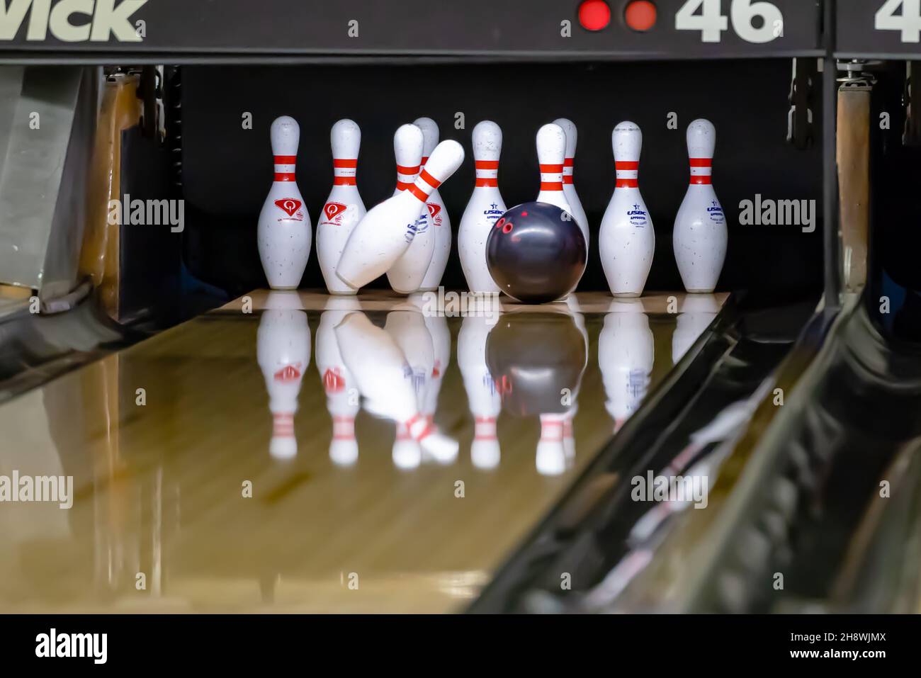 Bowling ball hitting pins at a bowling alley Stock Photo - Alamy