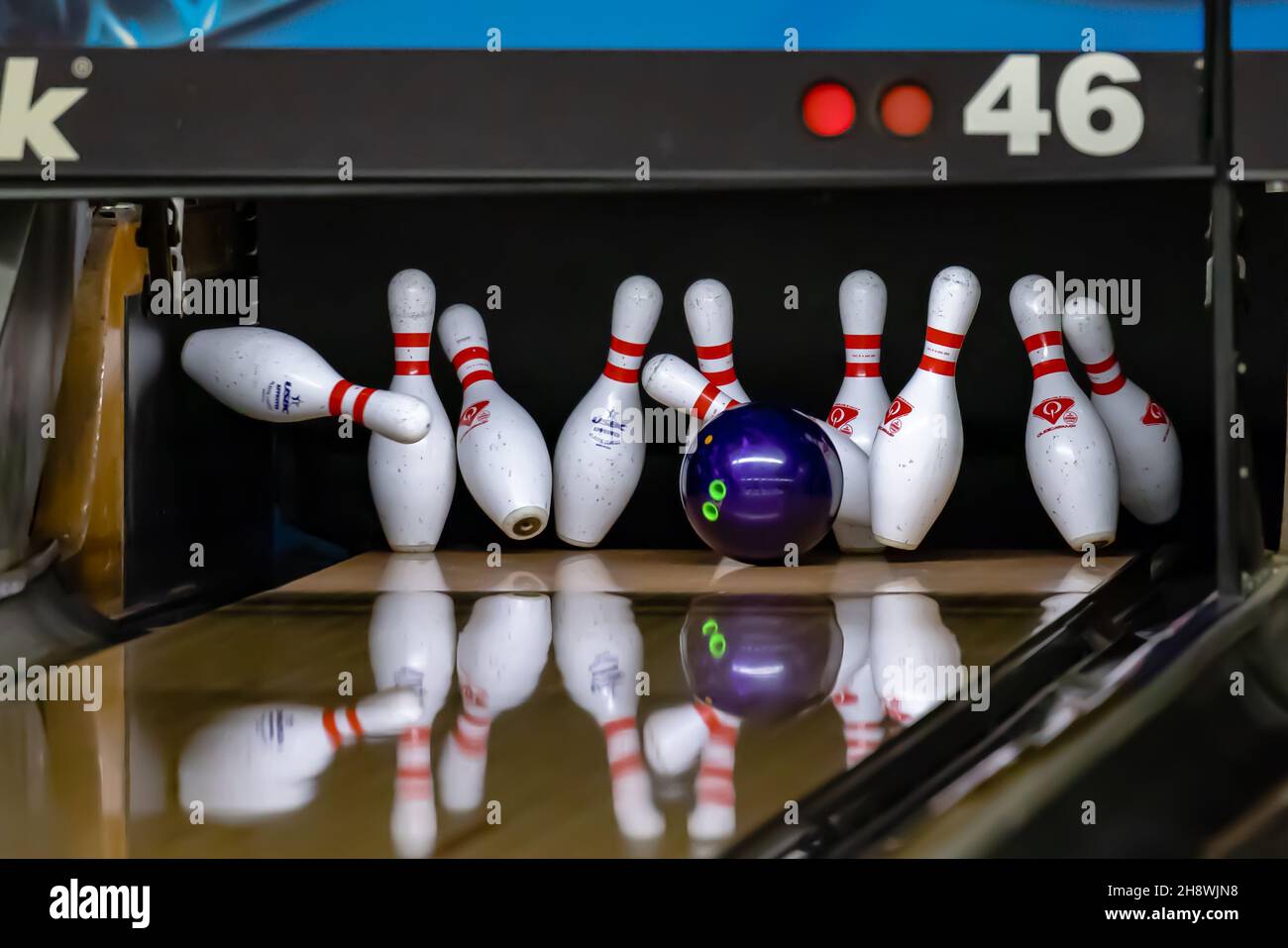 Bowling ball hitting pins at a bowling alley Stock Photo - Alamy