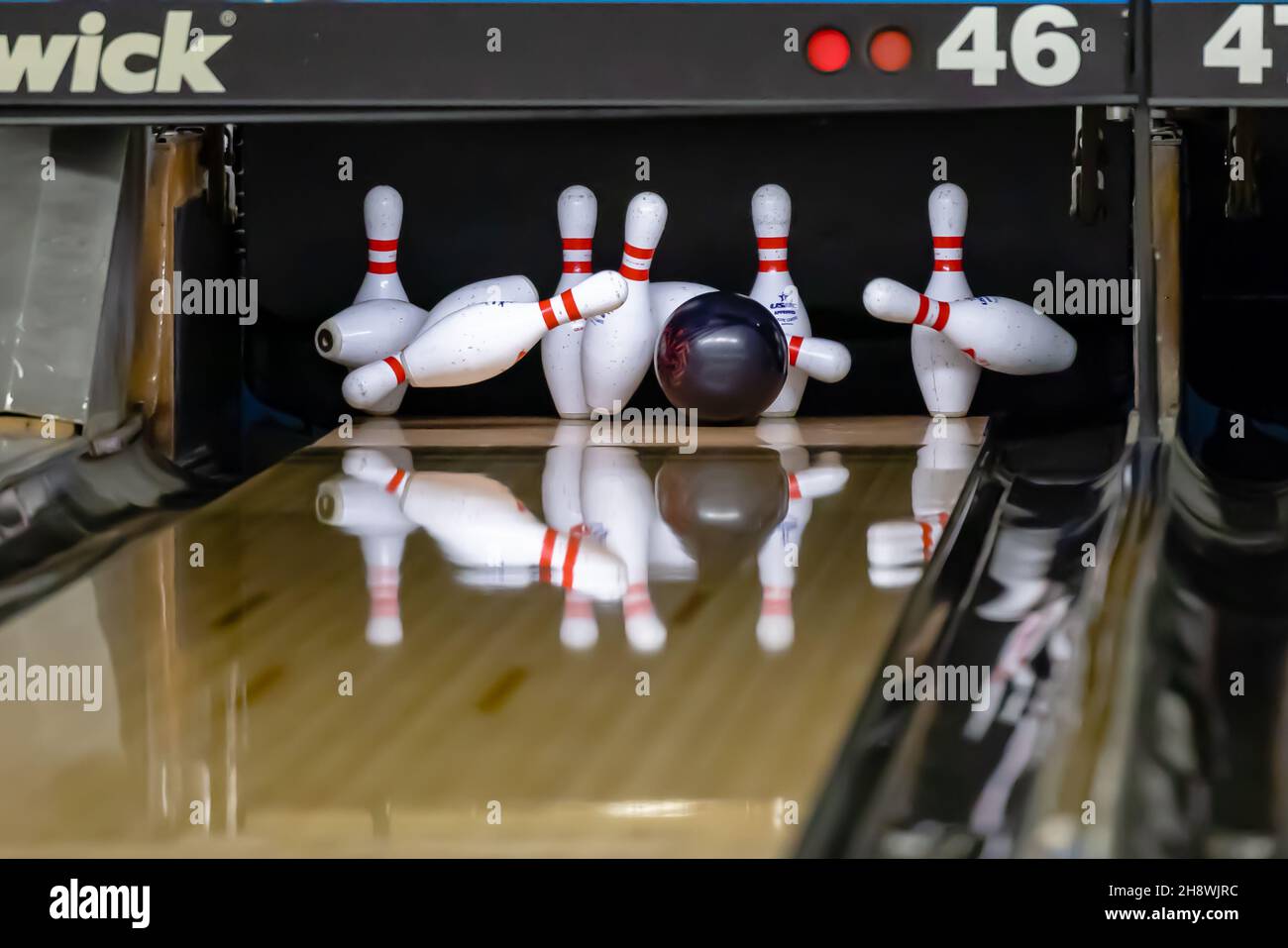 Bowling ball hitting pins at a bowling alley Stock Photo - Alamy