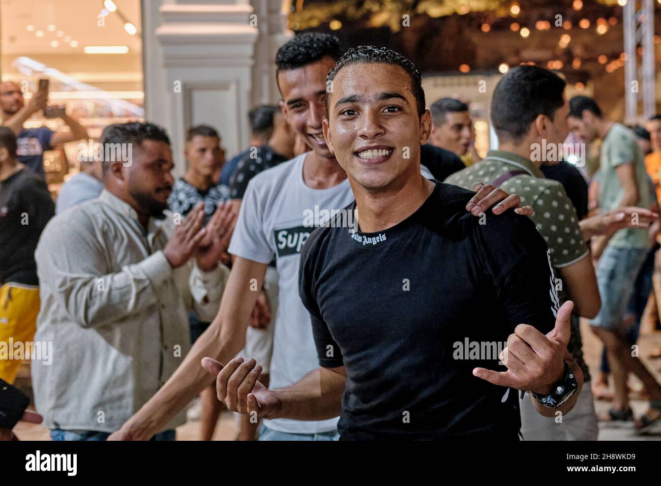 Happy young Egyptian looking at camera, smiling, showing gesture of ...