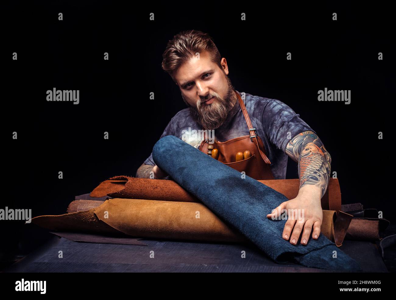 Worker of leather creating a new leather product Stock Photo - Alamy