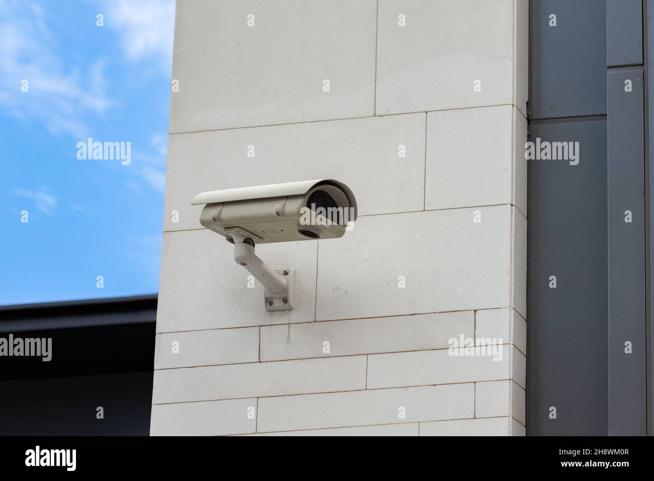 Surveillance camera built into the stone wall of the building Stock ...