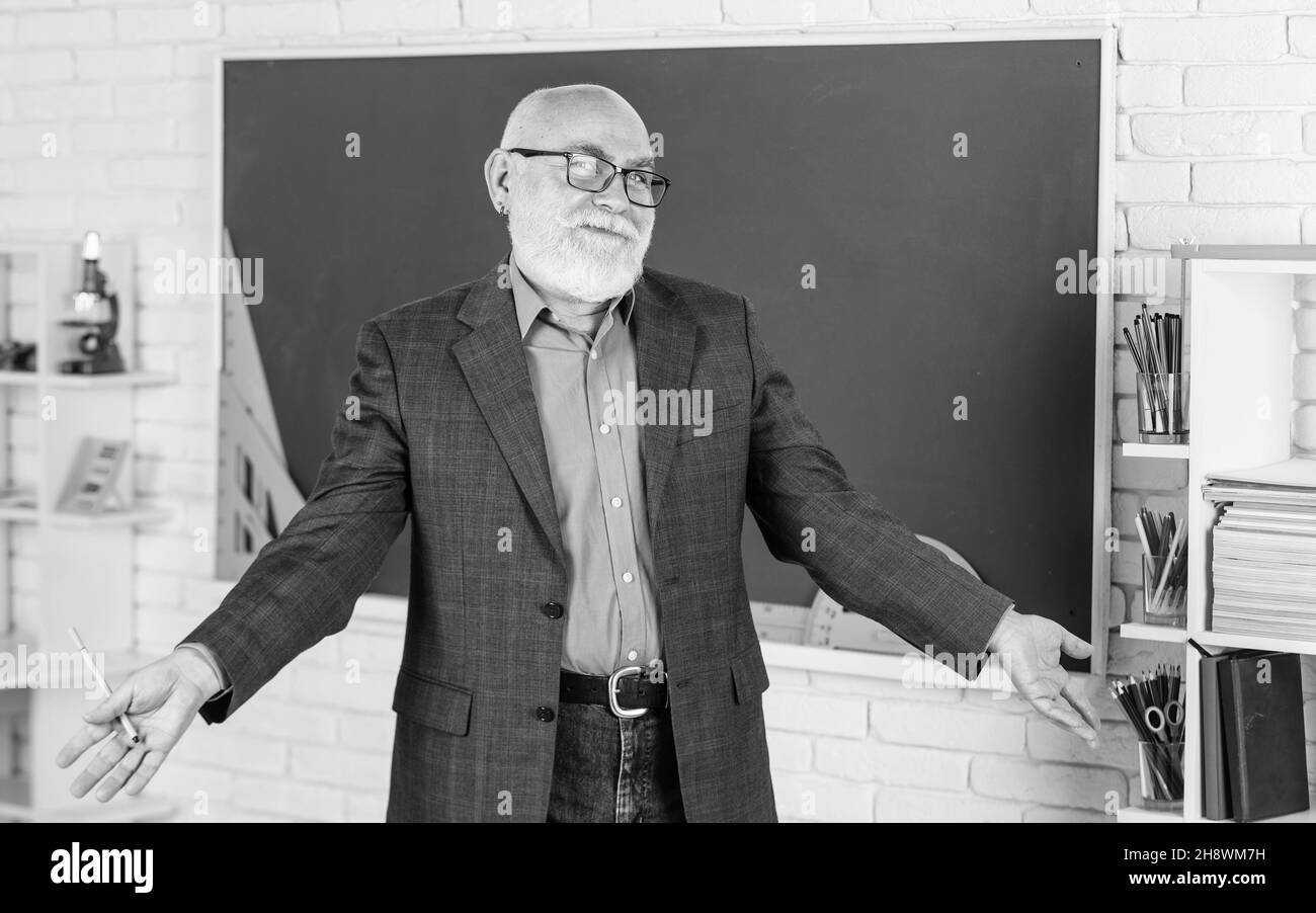 Senior intelligent man teacher at chalkboard. Teacher old school ...