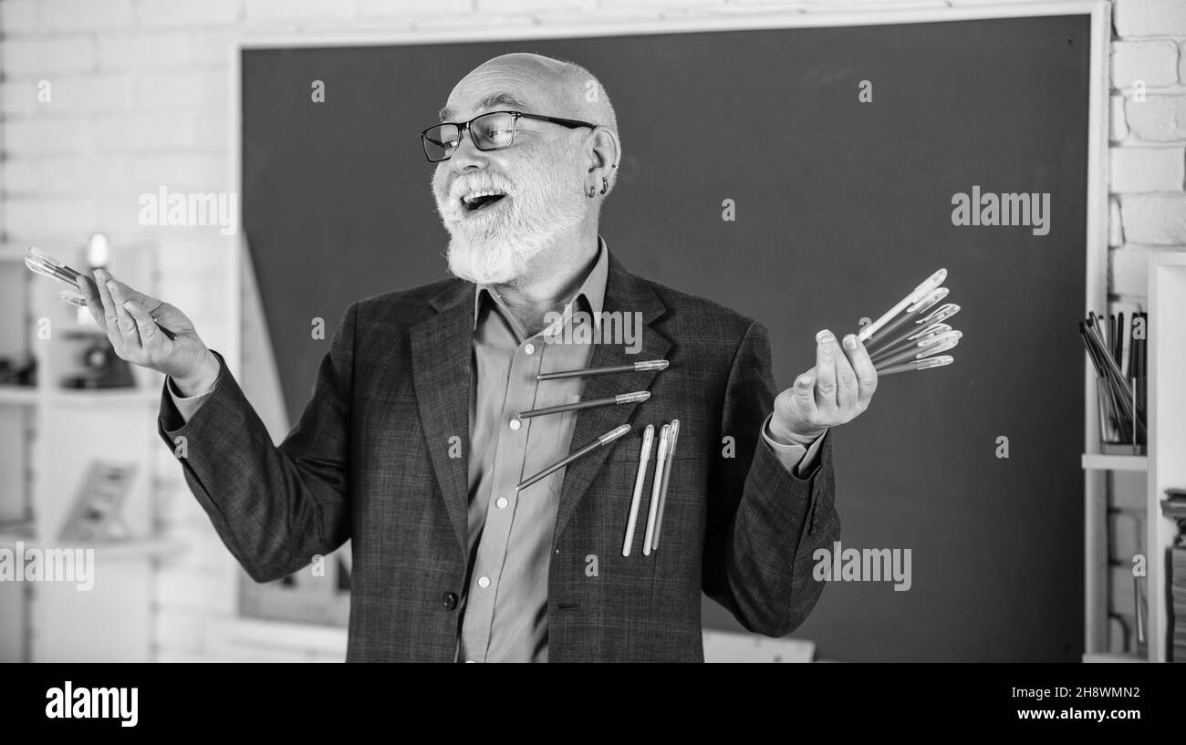 Senior intelligent man teacher at chalkboard. Education goals. School ...