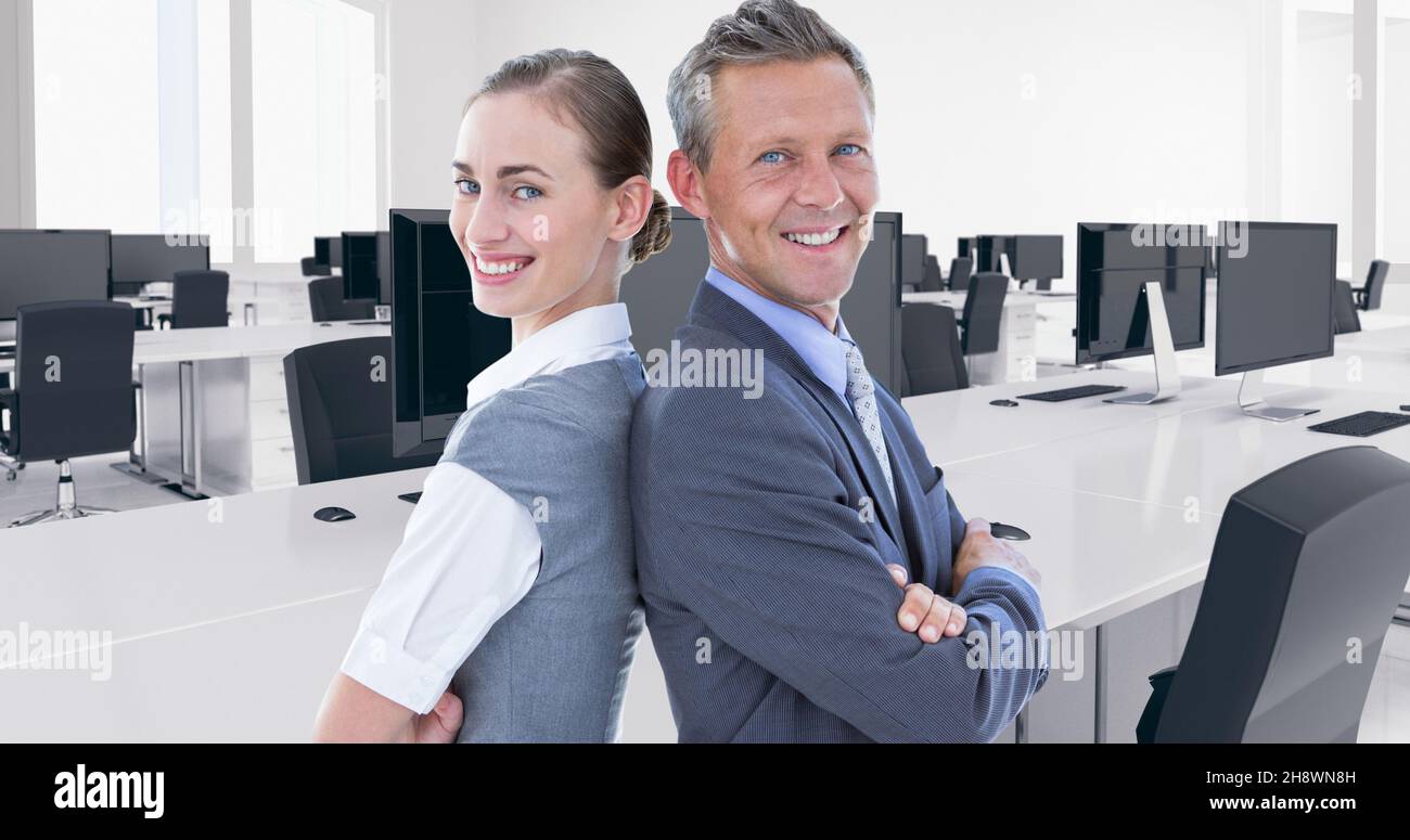 Digital composite of smiling businessman and businesswoman with arms ...