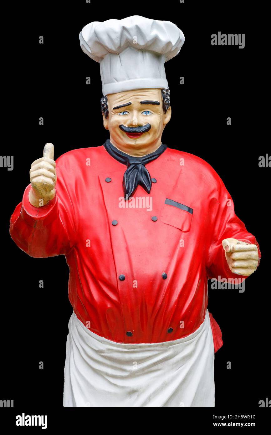 statue of a cook with a raised thumb isolated on a black background ...