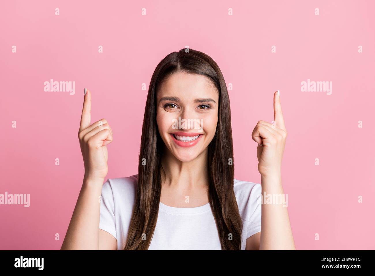 Portrait of attractive cheerful girl pointing forefingers up offer advert copy space isolated ...