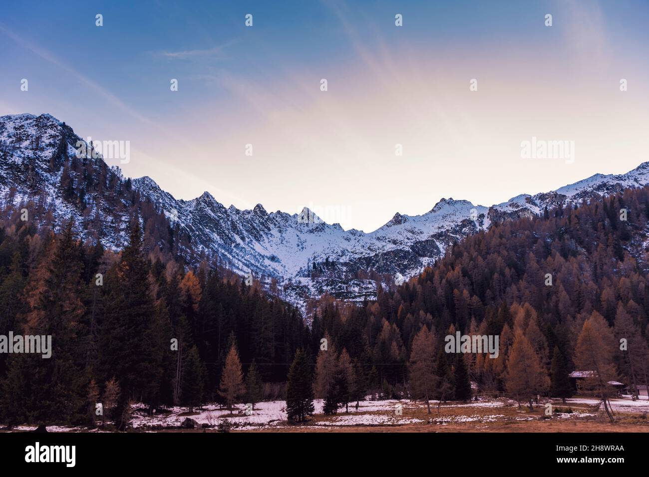 panoramic sunset views of the snowy peaks of the Italian Alps in autumn ...
