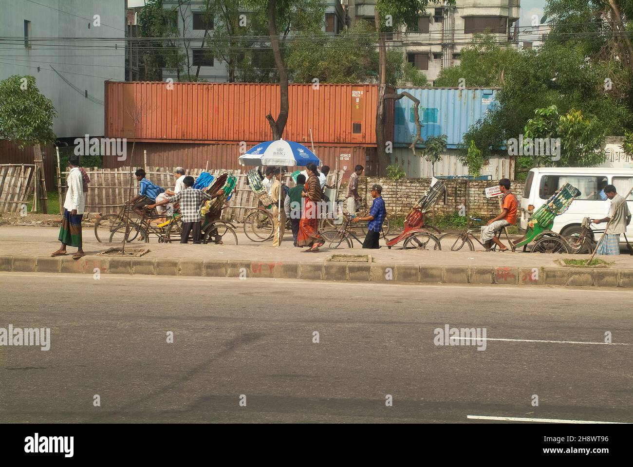 Dhaka, Bangladesh - September 17, 2007: Unidentified people by bus stop ...