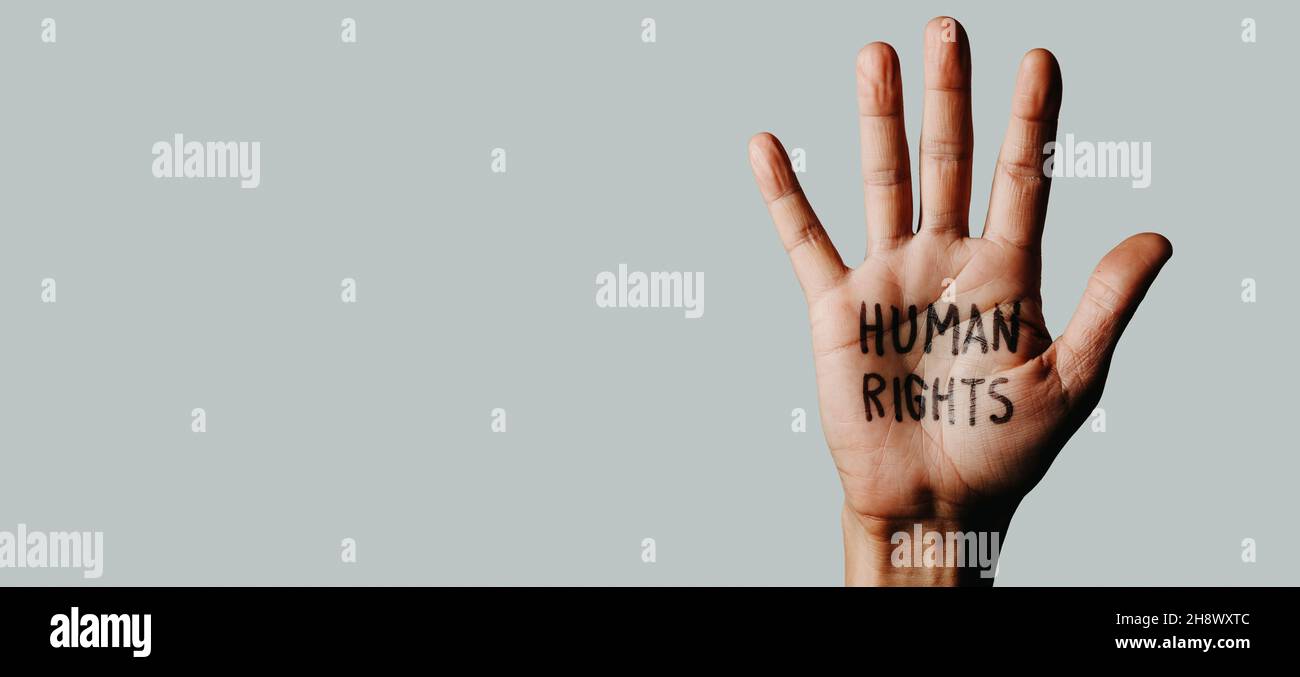 the hand of a man with the text human rights written in his palm, on an ...