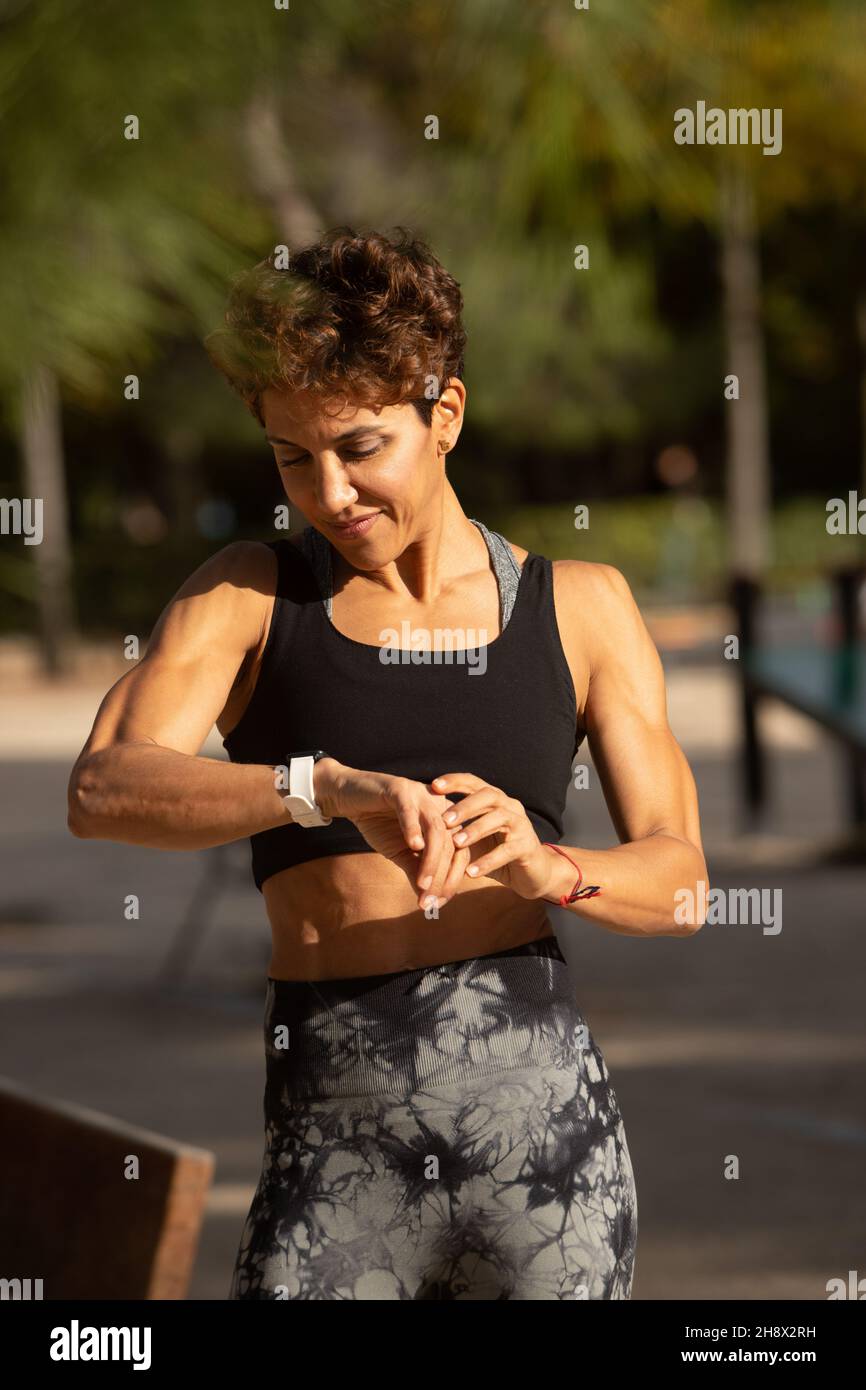 Self assured muscular Hispanic female runner with short hair in ...