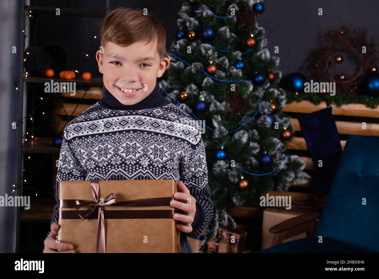 happy handsome pretty teenage blonde boy in knitted sweater holding new ...