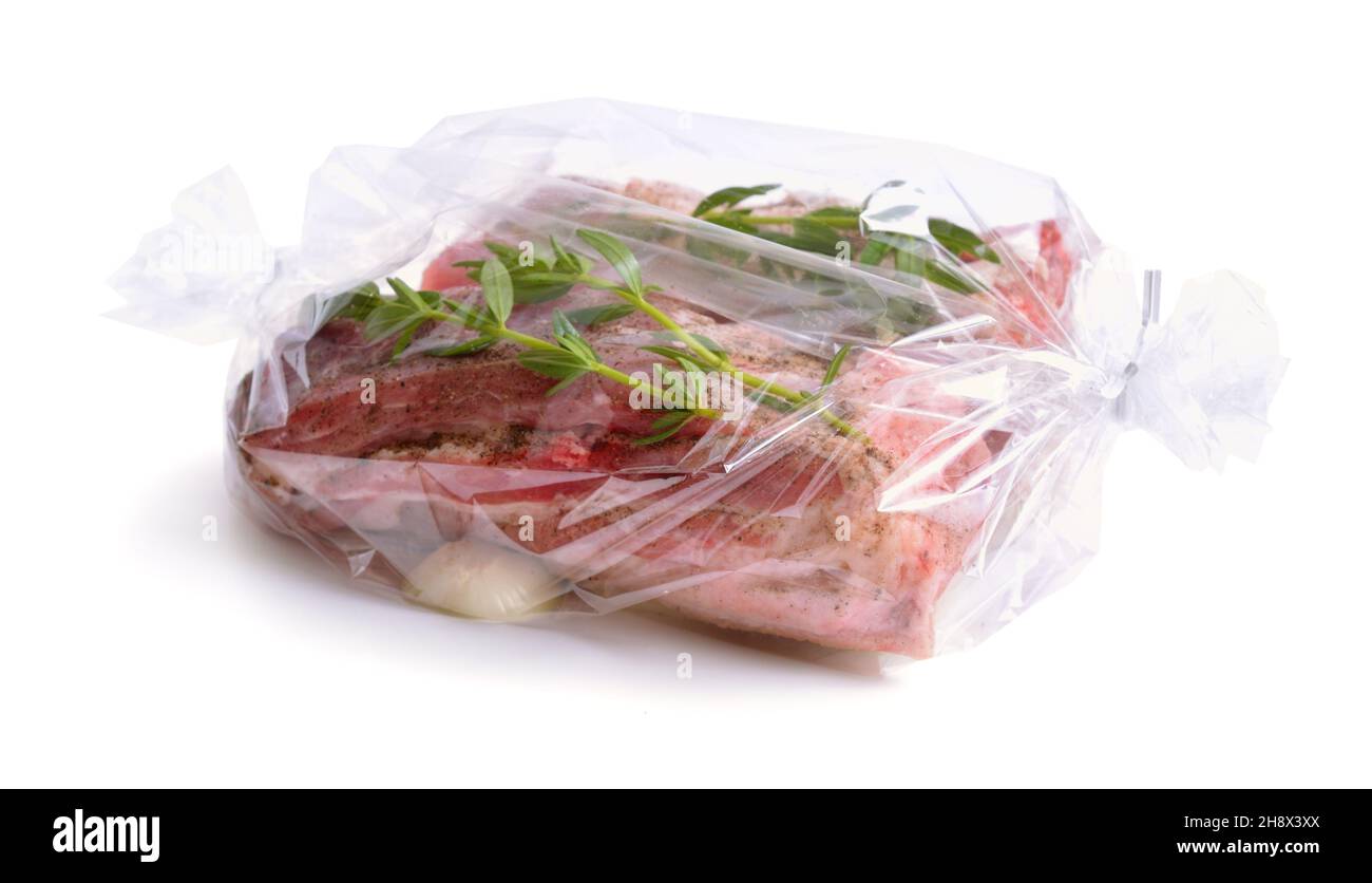 Fresh meat packaged in a sleeve for baking. Pork belly with greens ...