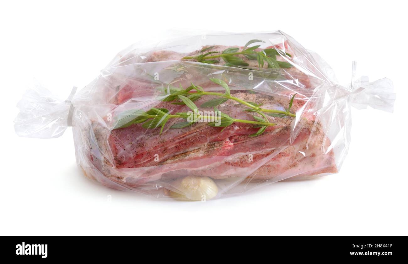 Fresh meat packaged in a sleeve for baking. Pork belly with greens ...