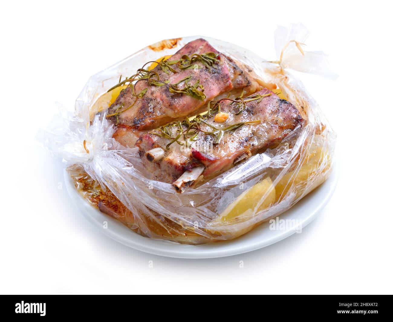 Baked meat packaged in a sleeve for baking. Pork belly with greens ...