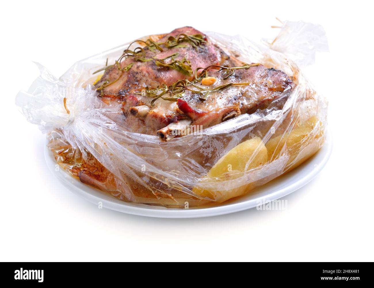 Baked meat packaged in a sleeve for baking. Pork belly with greens ...
