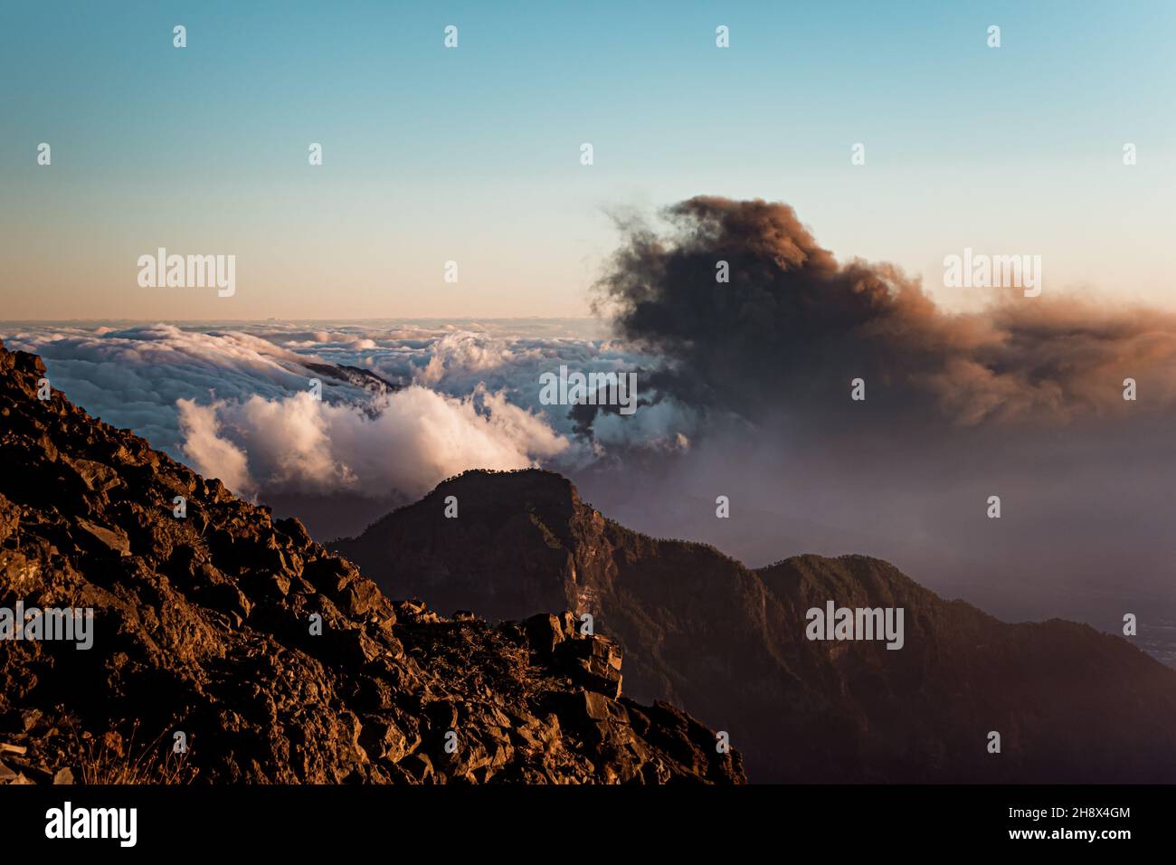 Spectacular landscape of huge rocky mountains silhouette and erupting ...