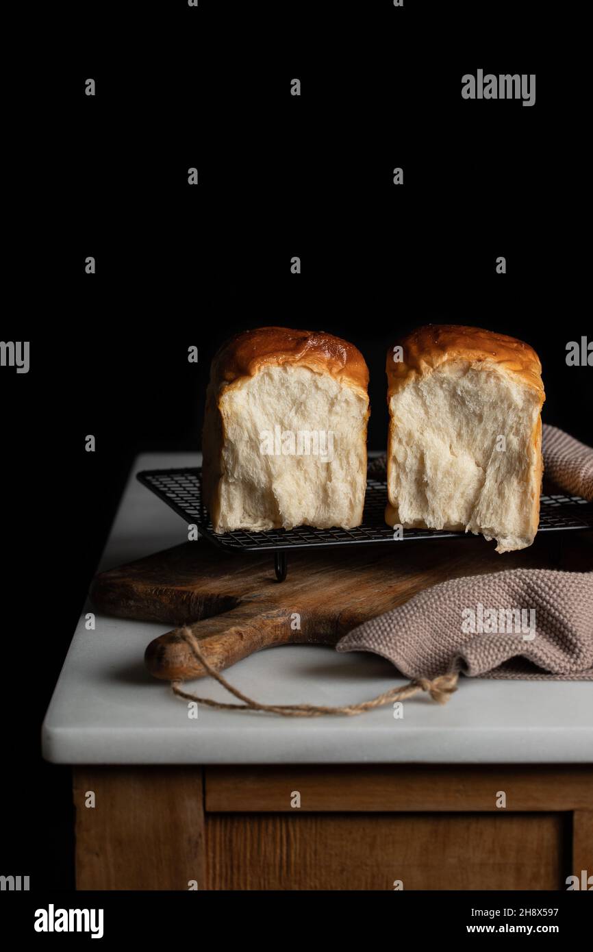 Delicious split halves of sandwich bread on grill tray placed on ...