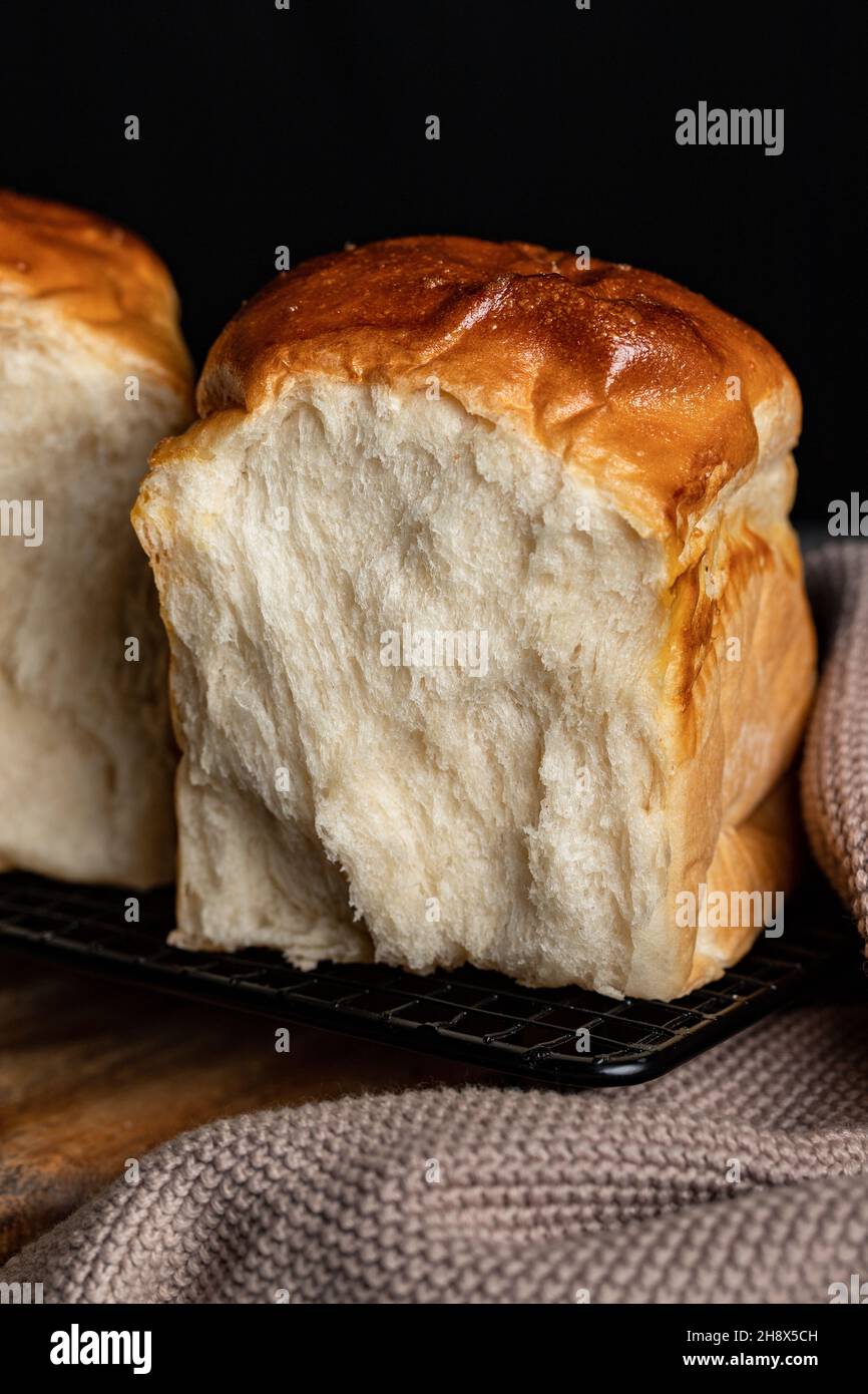 Delicious split halves of sandwich bread on grill tray placed on ...