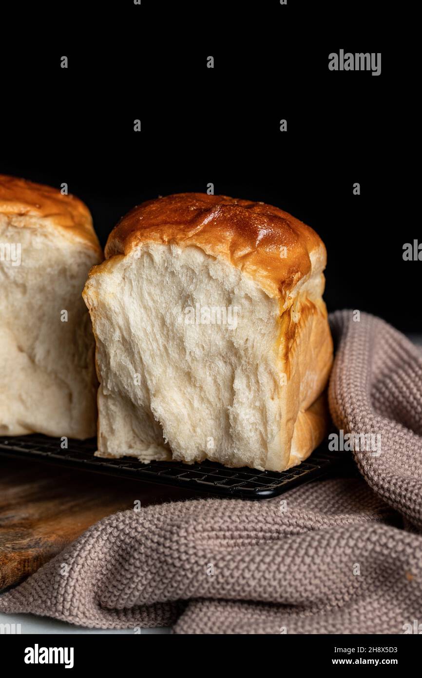 Delicious split halves of sandwich bread on grill tray placed on ...