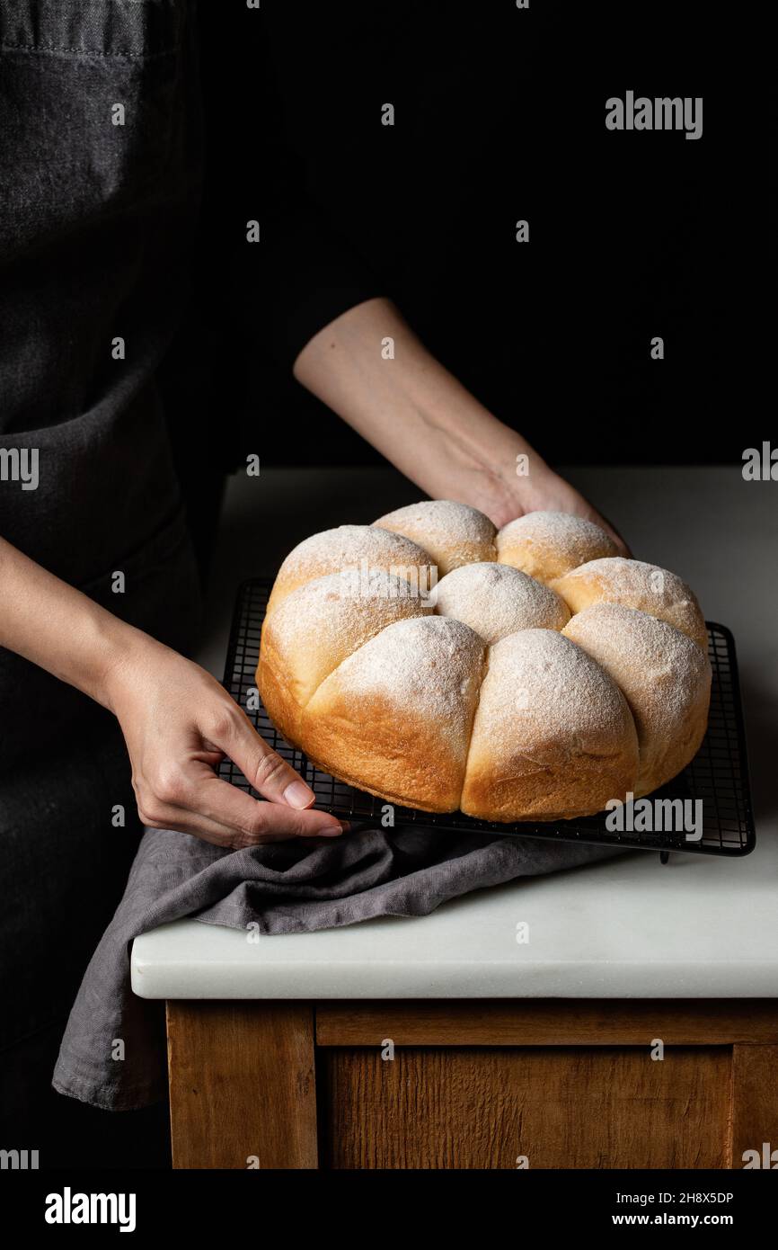 High angle of crop unrecognizable baker standing at counter with fresh ...