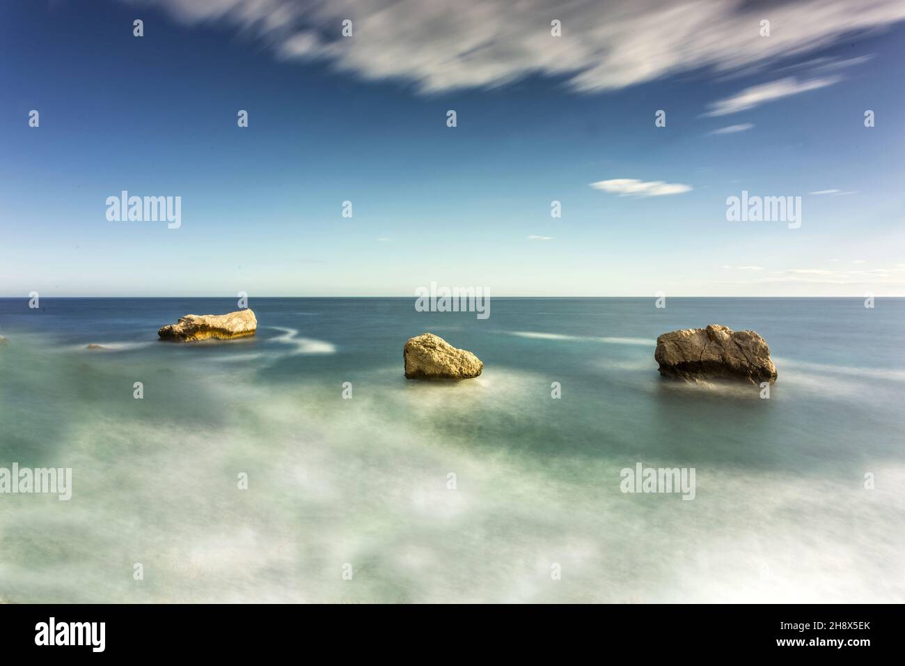 Beautiful scene of rocks in the water on the beach Stock Photo - Alamy