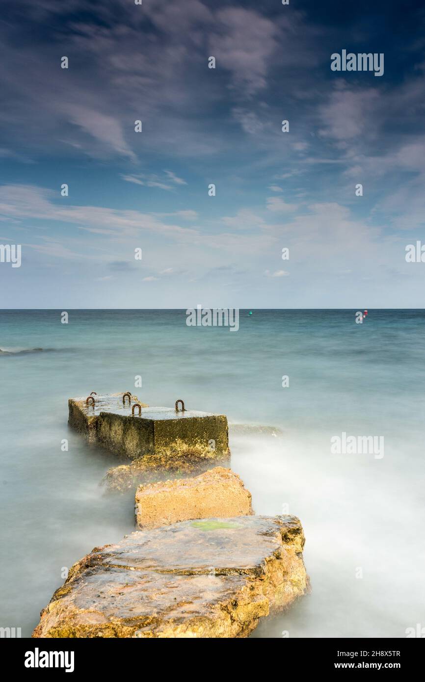 Beautiful scene of rocks in the water at the beach Stock Photo - Alamy