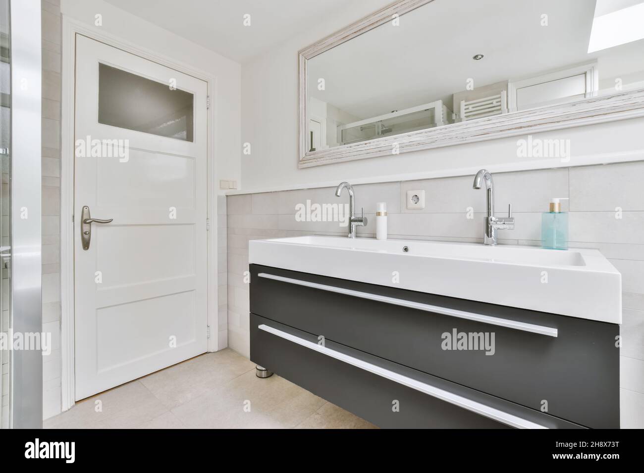 Design of lovely bathroom with long sink Stock Photo - Alamy