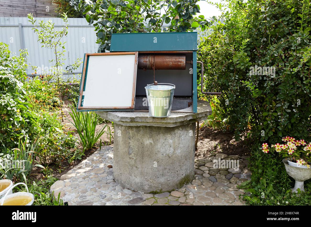 Old draw-well in European village. Retro stone water well in rural area ...