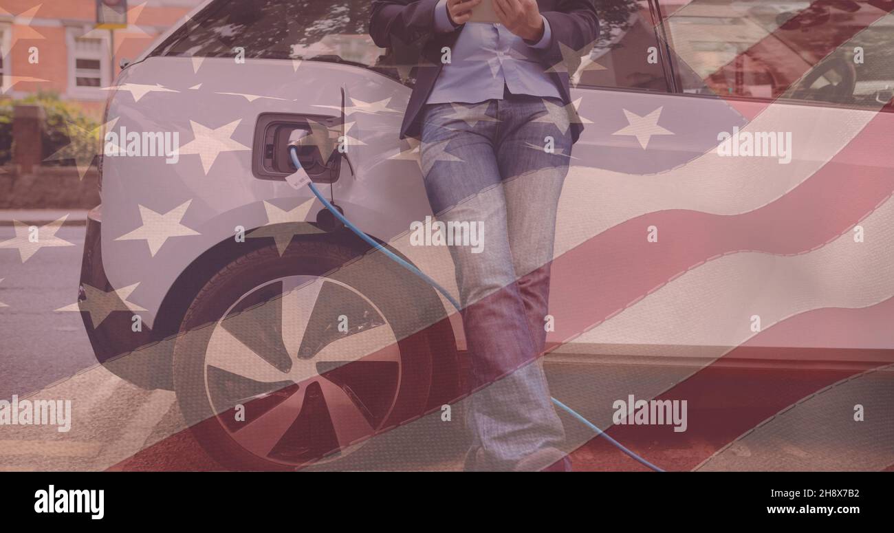 Double exposure of american flag over man using smartphone leaning on ...