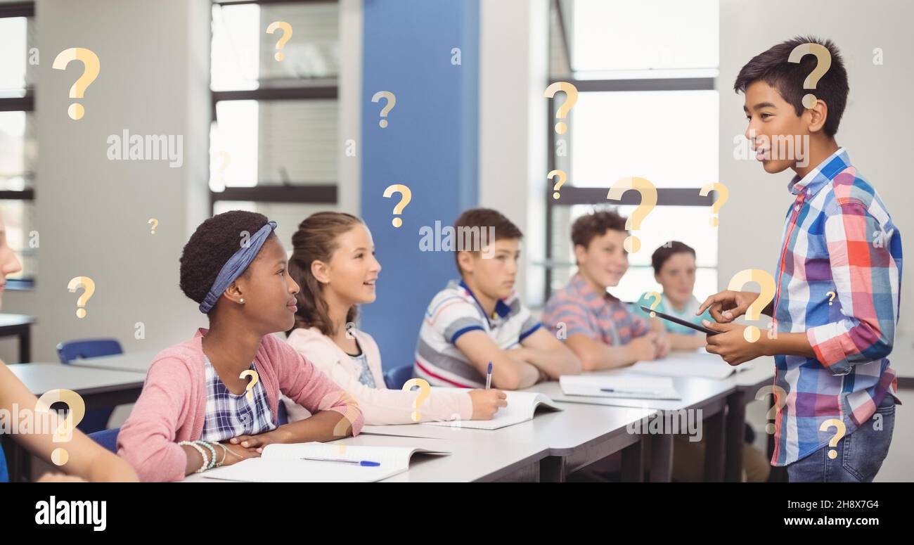 Digital composite of question marks over schoolboy giving presentation ...