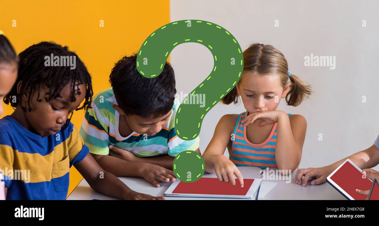 Digital composite of green question mark over elementary students using ...
