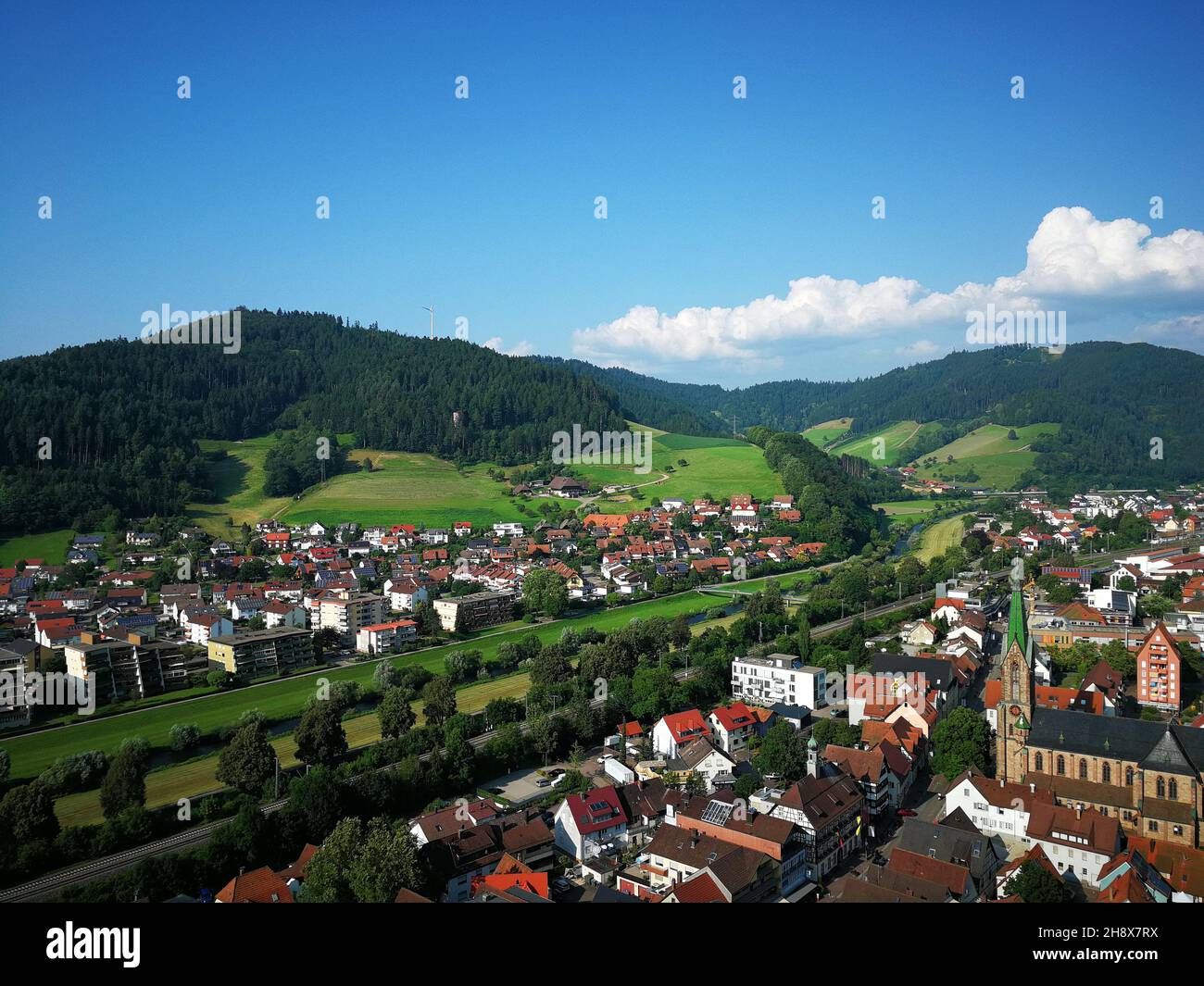 Aerial view of a small town surrounded by hills Stock Photo - Alamy