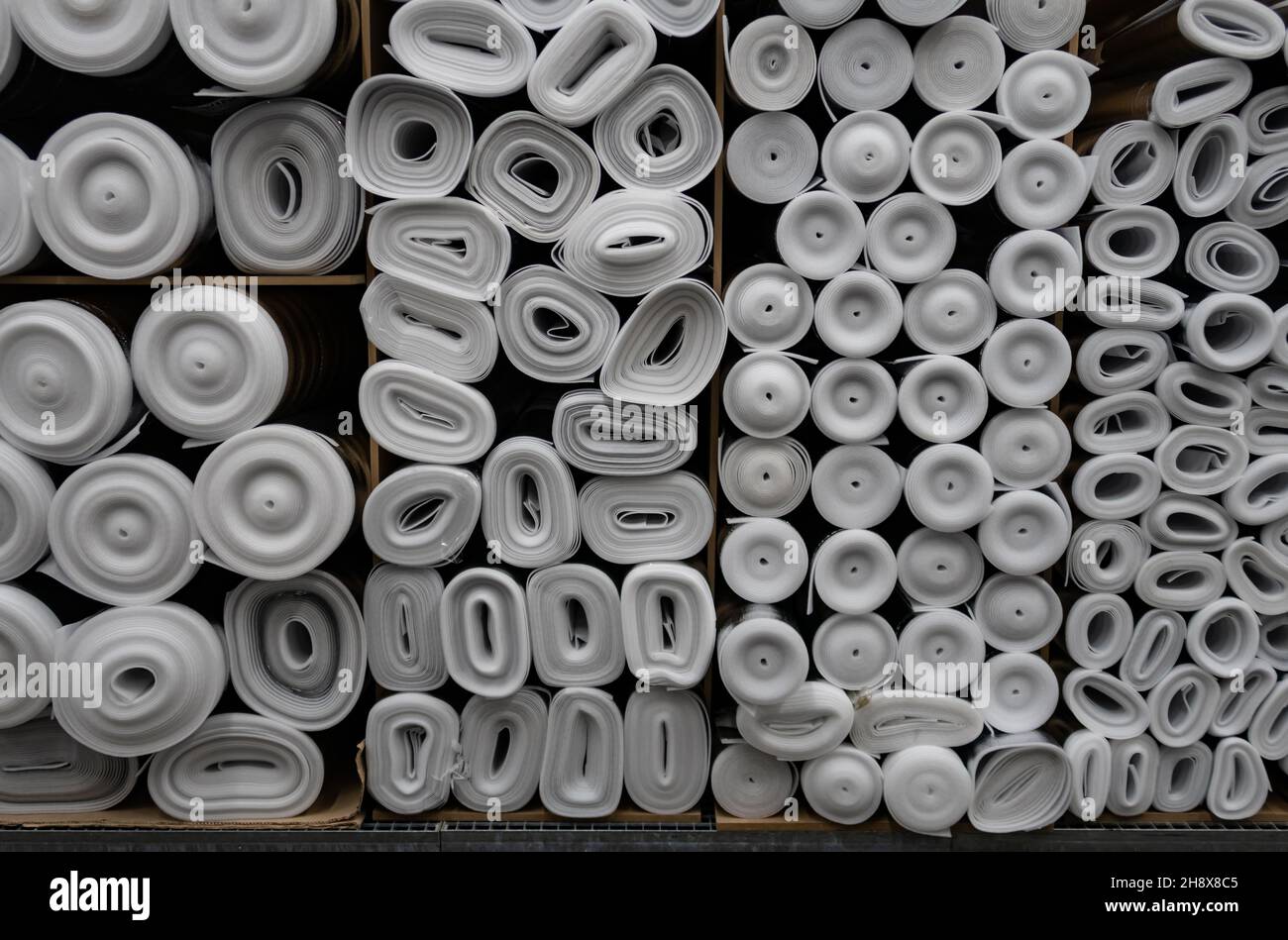 a roll of special insulation material is folded on a rack. High quality ...