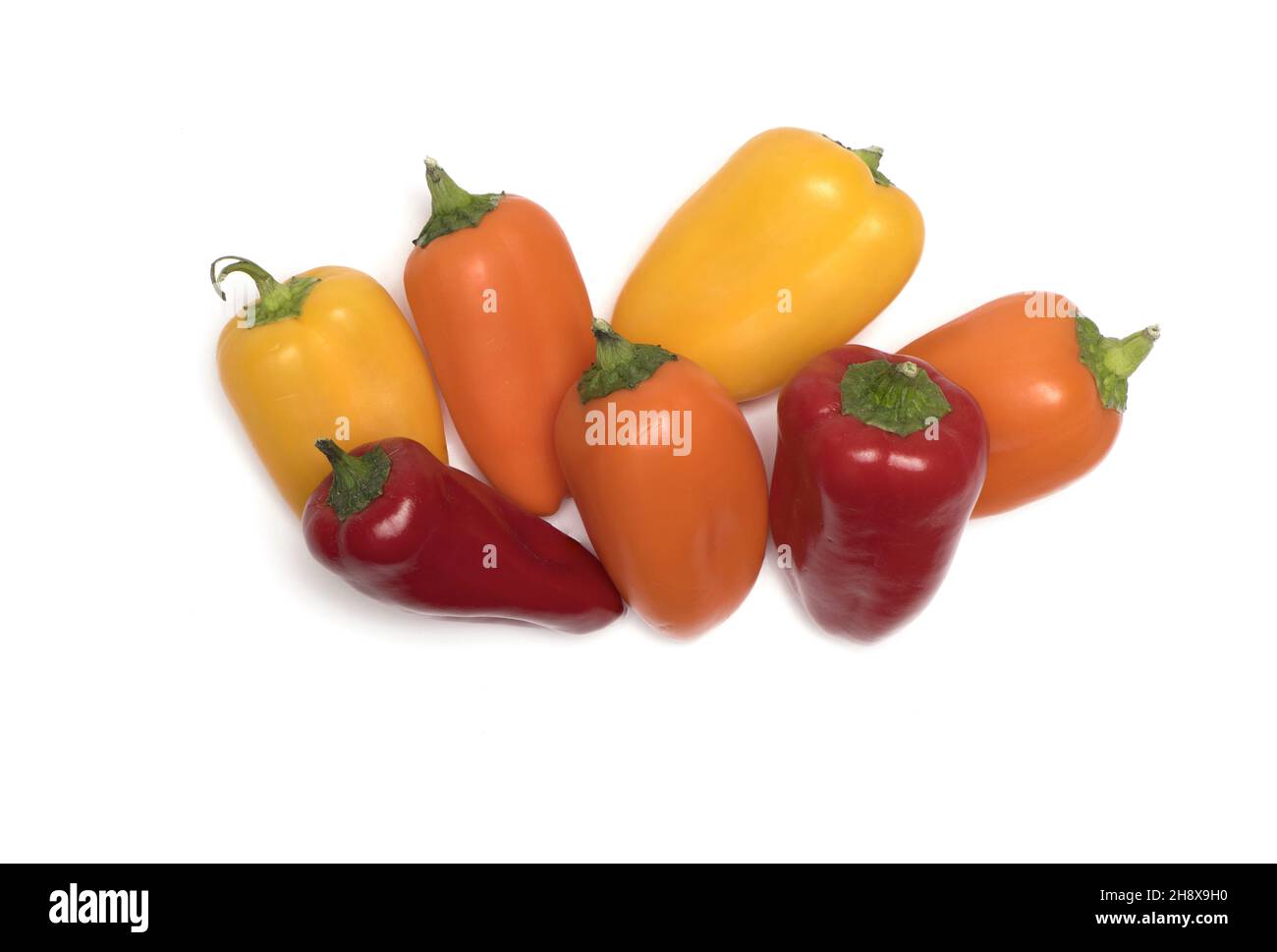various different colored snack bell pepper pods in yellow orange and ...