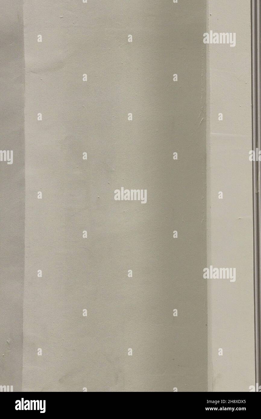 Vertical shot of a concrete building with an old white weathered grungy ...