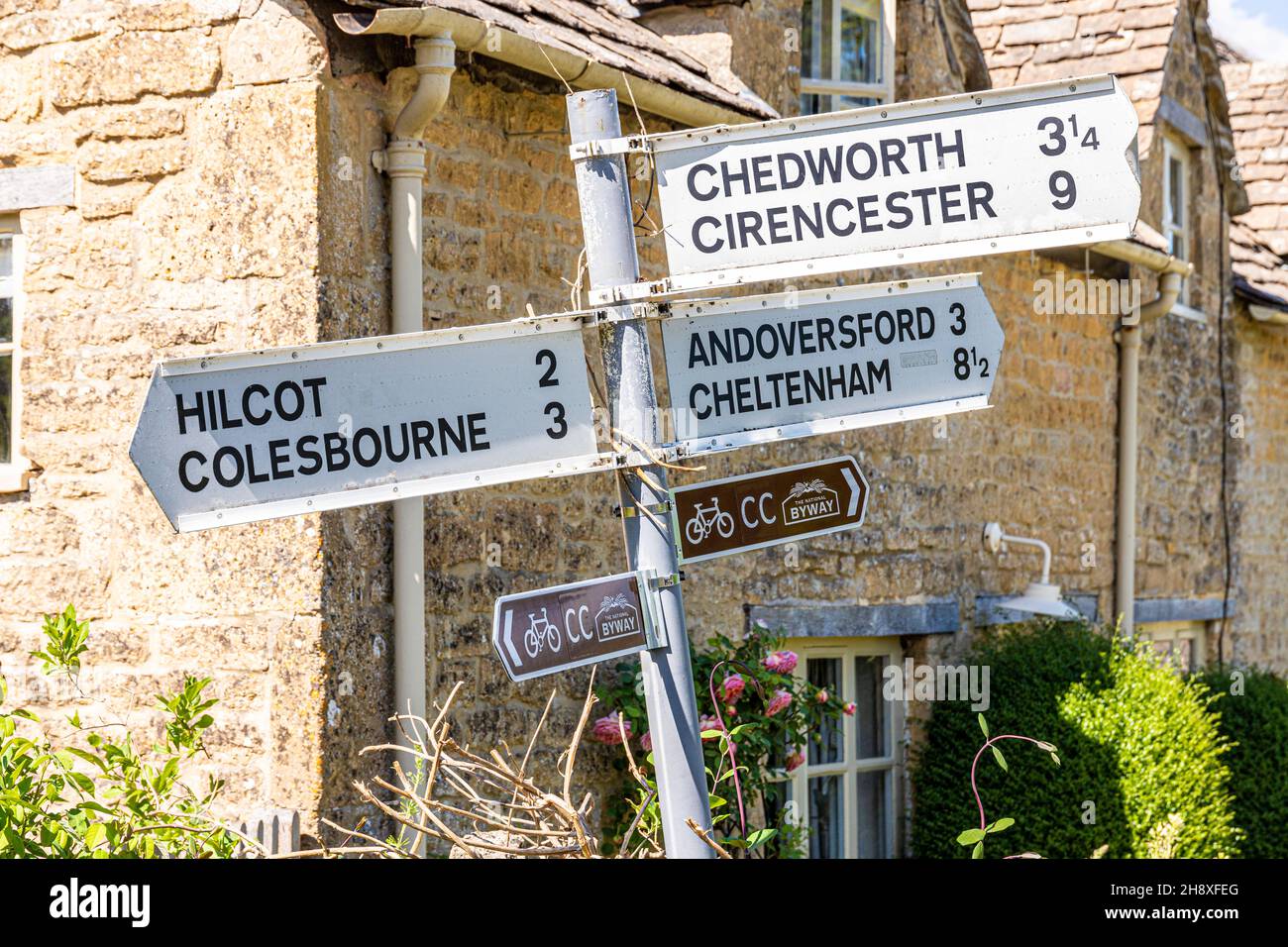 A rathey cranky road sign in the Cotswold village of Withington ...