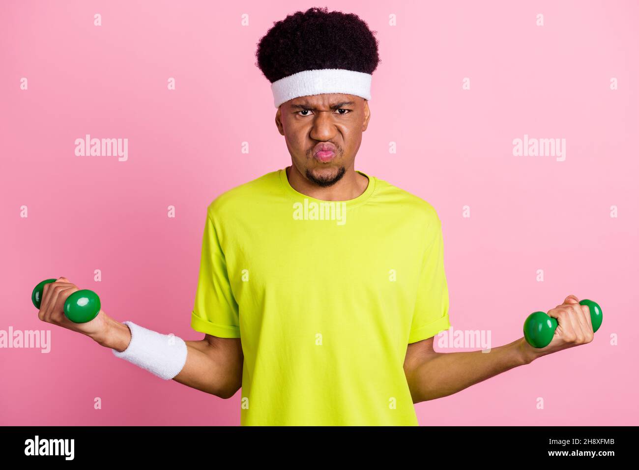 Portrait of attractive mad guy doing exercise body building hobby gym ...