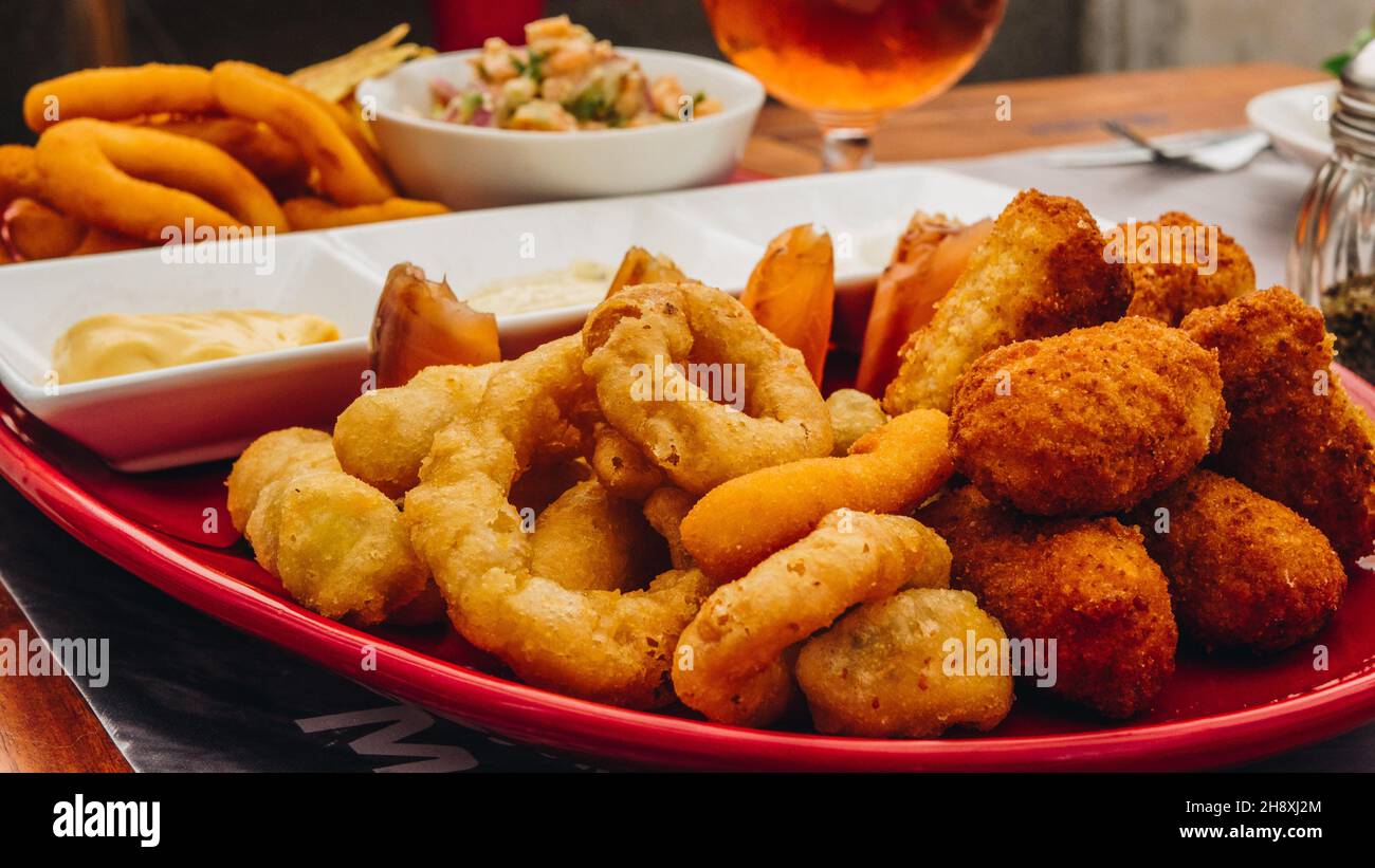 Plate of fried delicious appetizers at a restaurant Stock Photo - Alamy