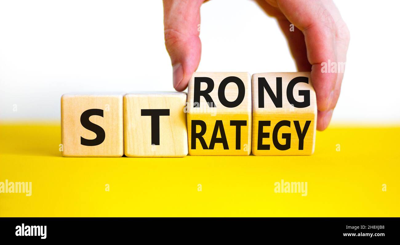 Strong strategy symbol. Businessman turns wooden cubes with words ...