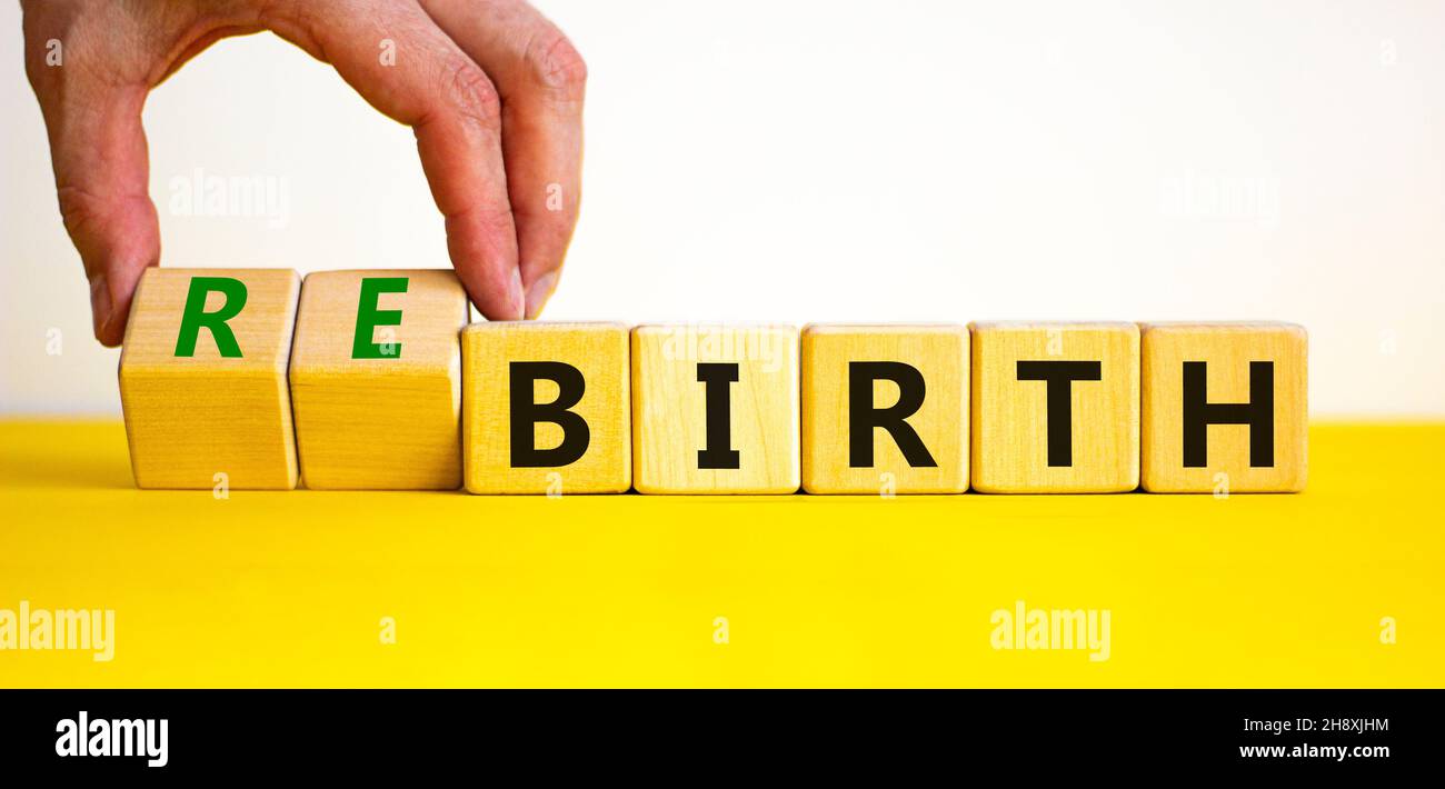 Birth or rebirth symbol. Businessman turns wooden cubes and changes the ...